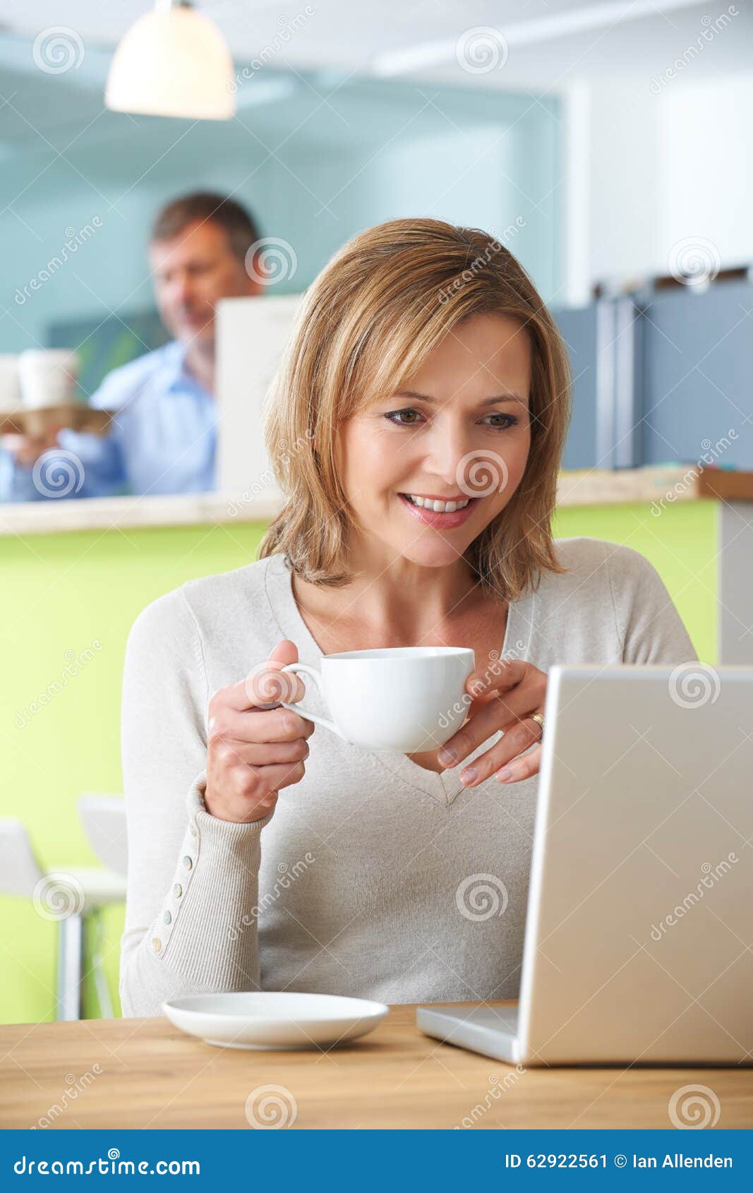 Woman Using Laptop in Cafe stock image. Image of urban - 62922561