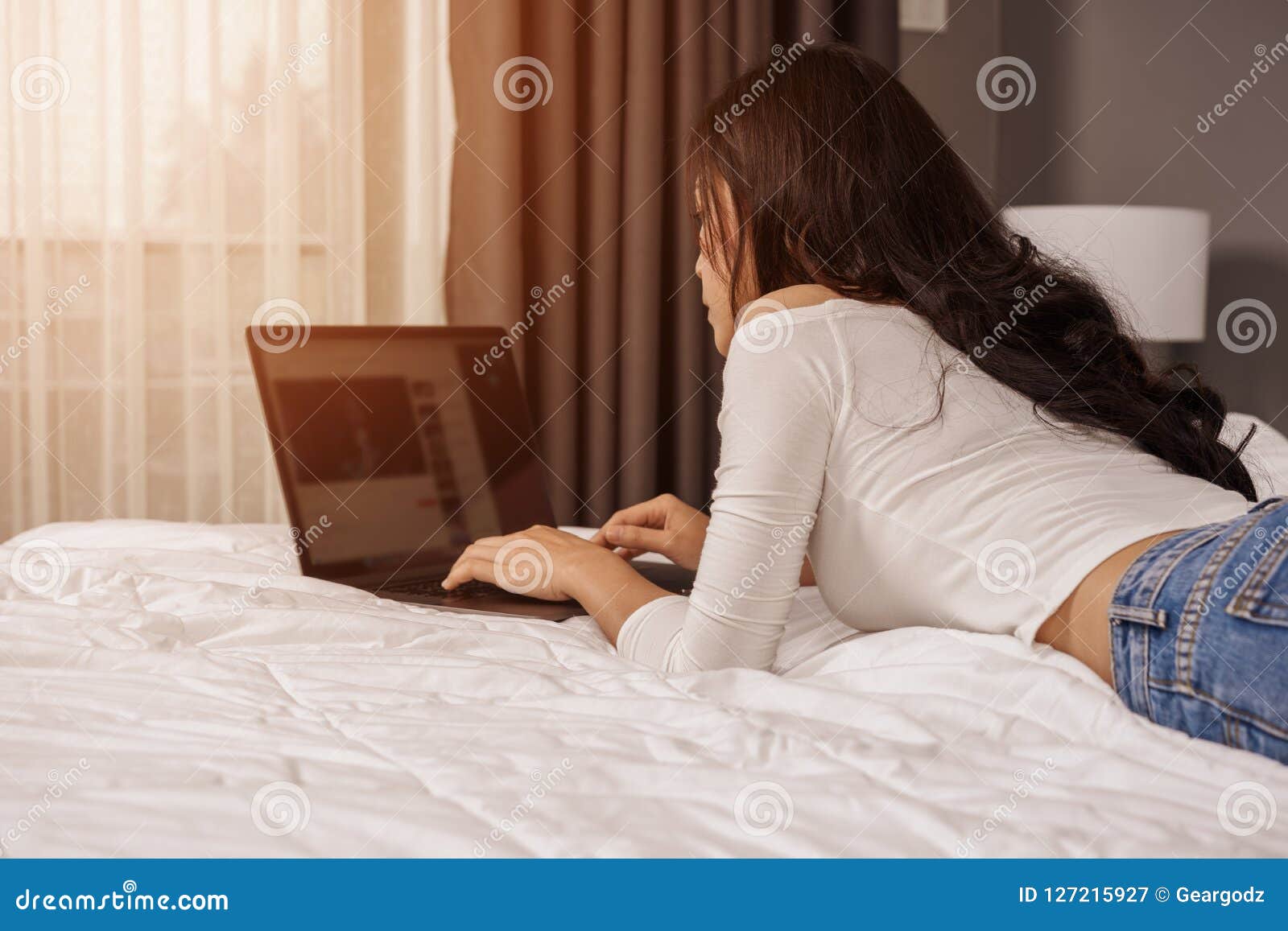 Woman Using Laptop Computer on Bed Stock Image - Image of lying ...