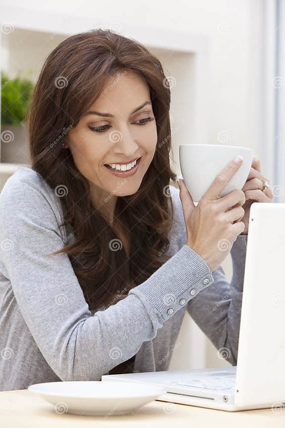 Woman Using Laptop Computer Drinking Tea or Coffee Stock Image - Image ...