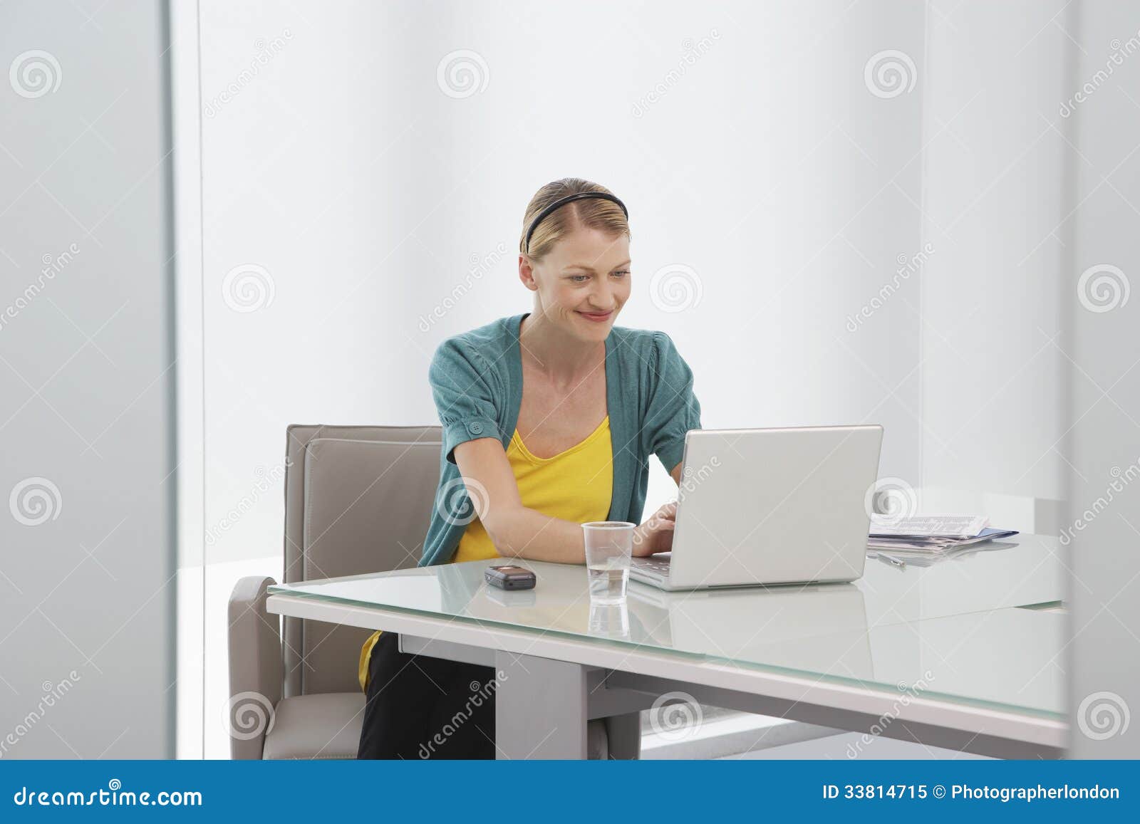Woman Using Laptop in Office Stock Image - Image of beautiful, paper ...
