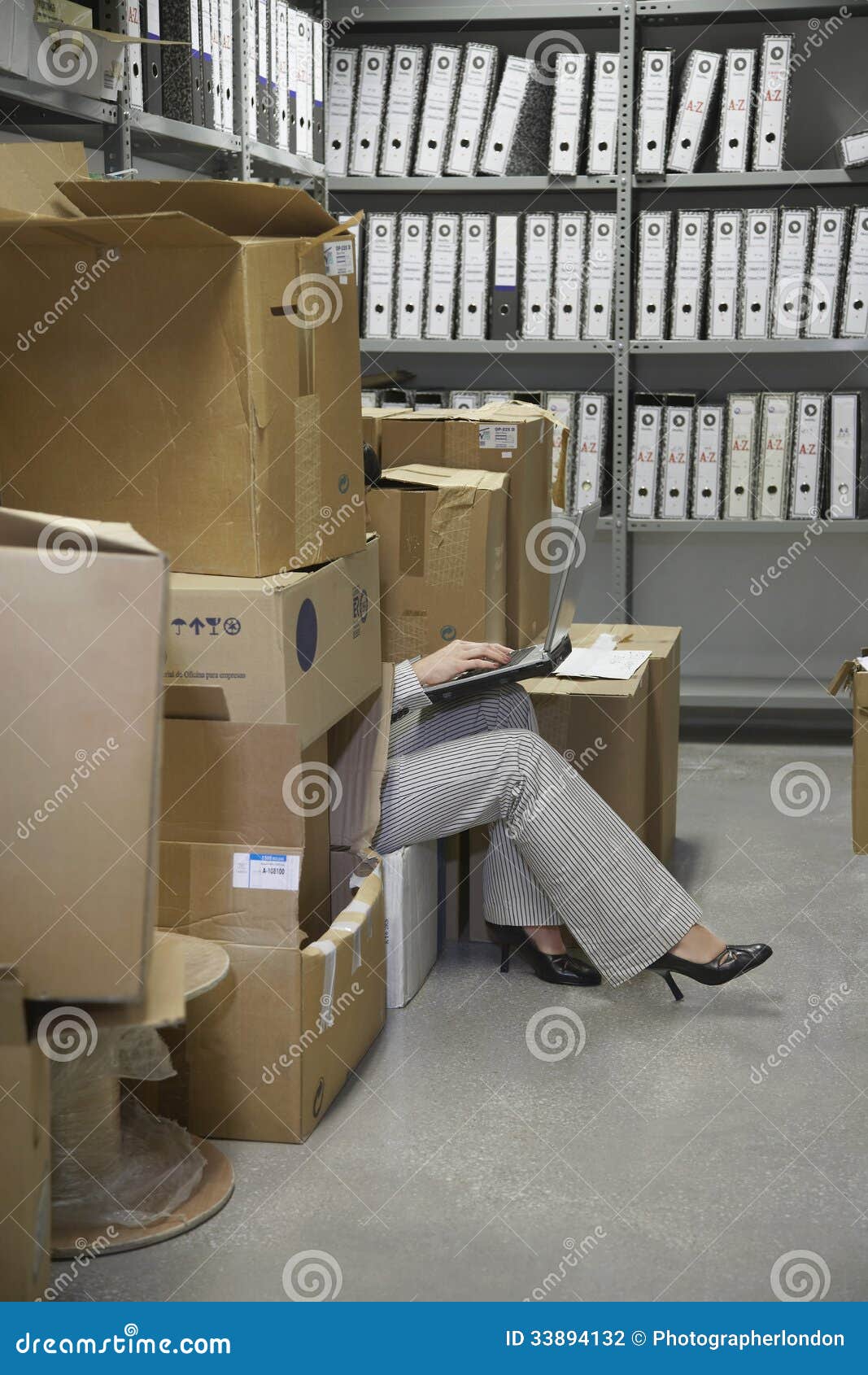 Woman Using Laptop in Office Storage Room Stock Photo - Image of ...