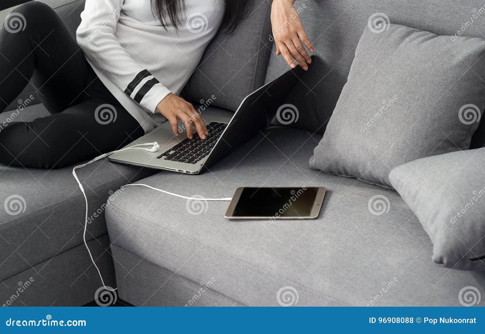 Woman Using Laptop and Tablet, Sitting on Sofa Stock Photo - Image of ...