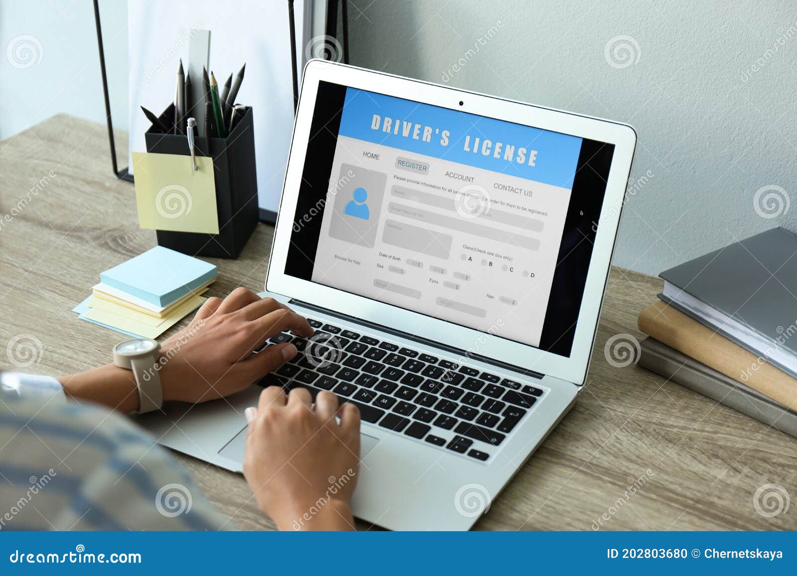 Woman Using Laptop To Fill Driver`s License Application Form at Table ...