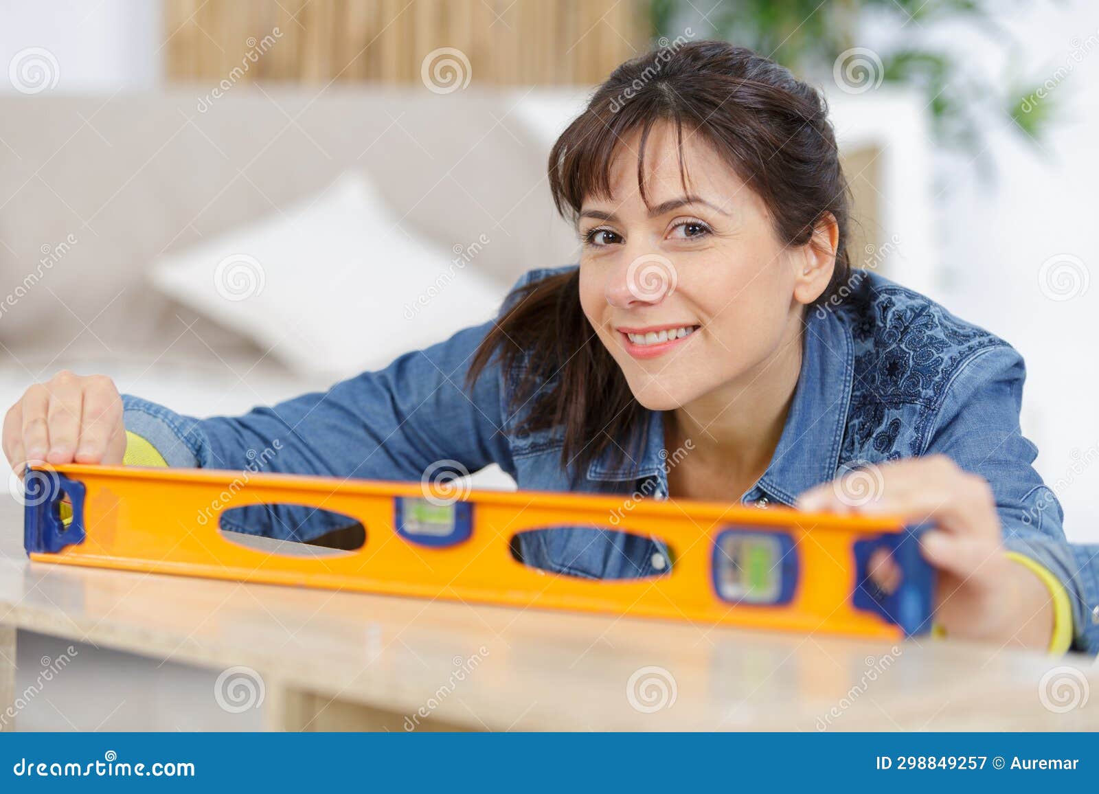 Woman using leveling tool stock image. Image of craft - 298849257