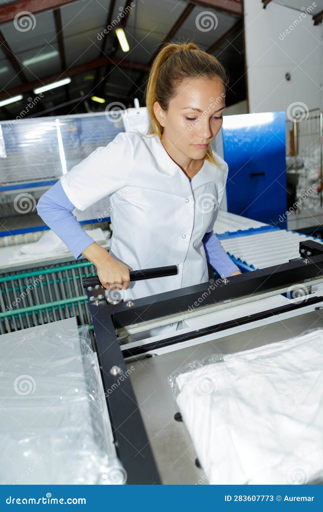 Woman Using Machine To Seal Linen in Plastic Stock Image - Image of ...