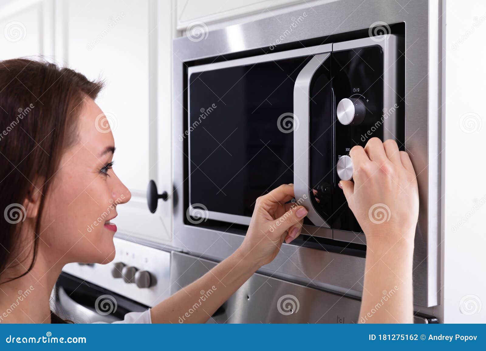 Woman Using Microwave Oven stock photo. Image of hand - 181275162