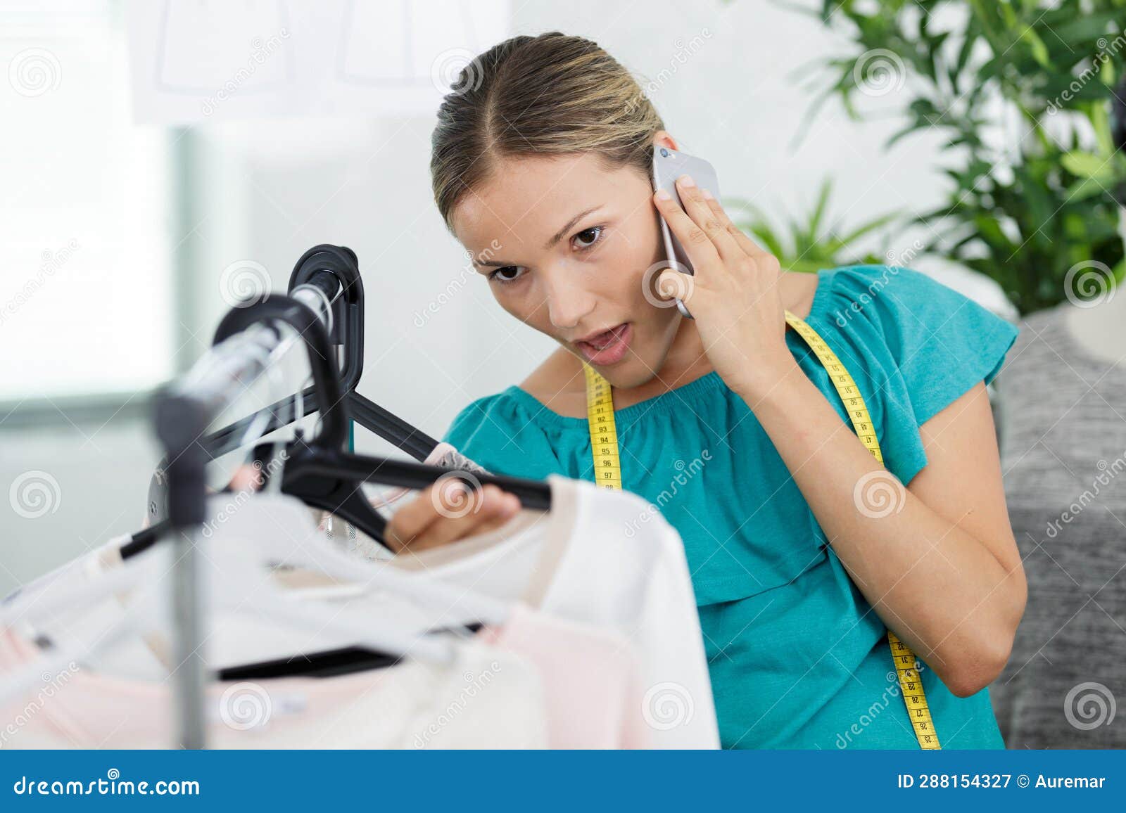 Woman Using Mobile Phone in Clothes Shop Stock Image - Image of ...