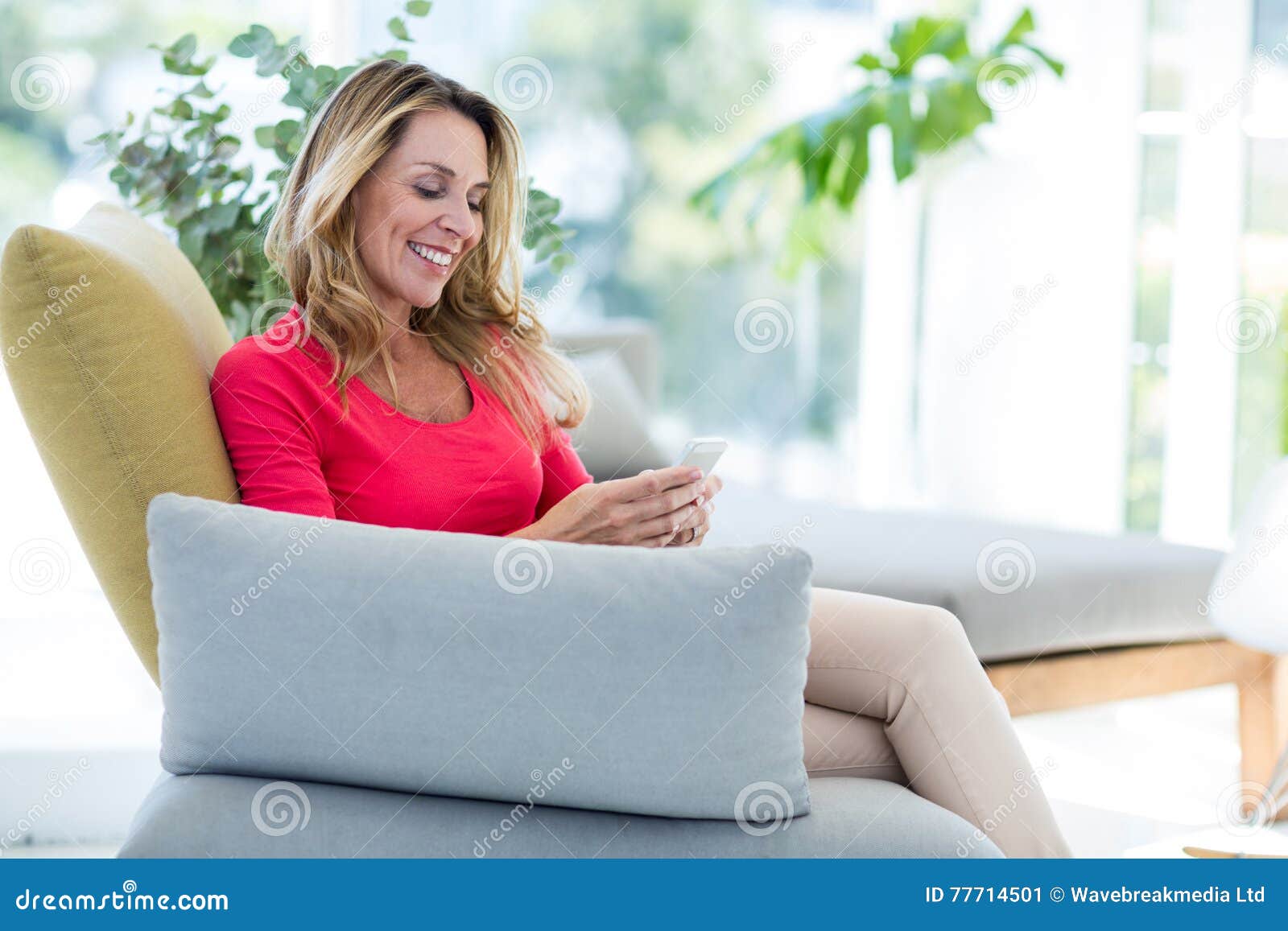 Woman Using Mobile Phone on Couch Stock Image - Image of clothing ...