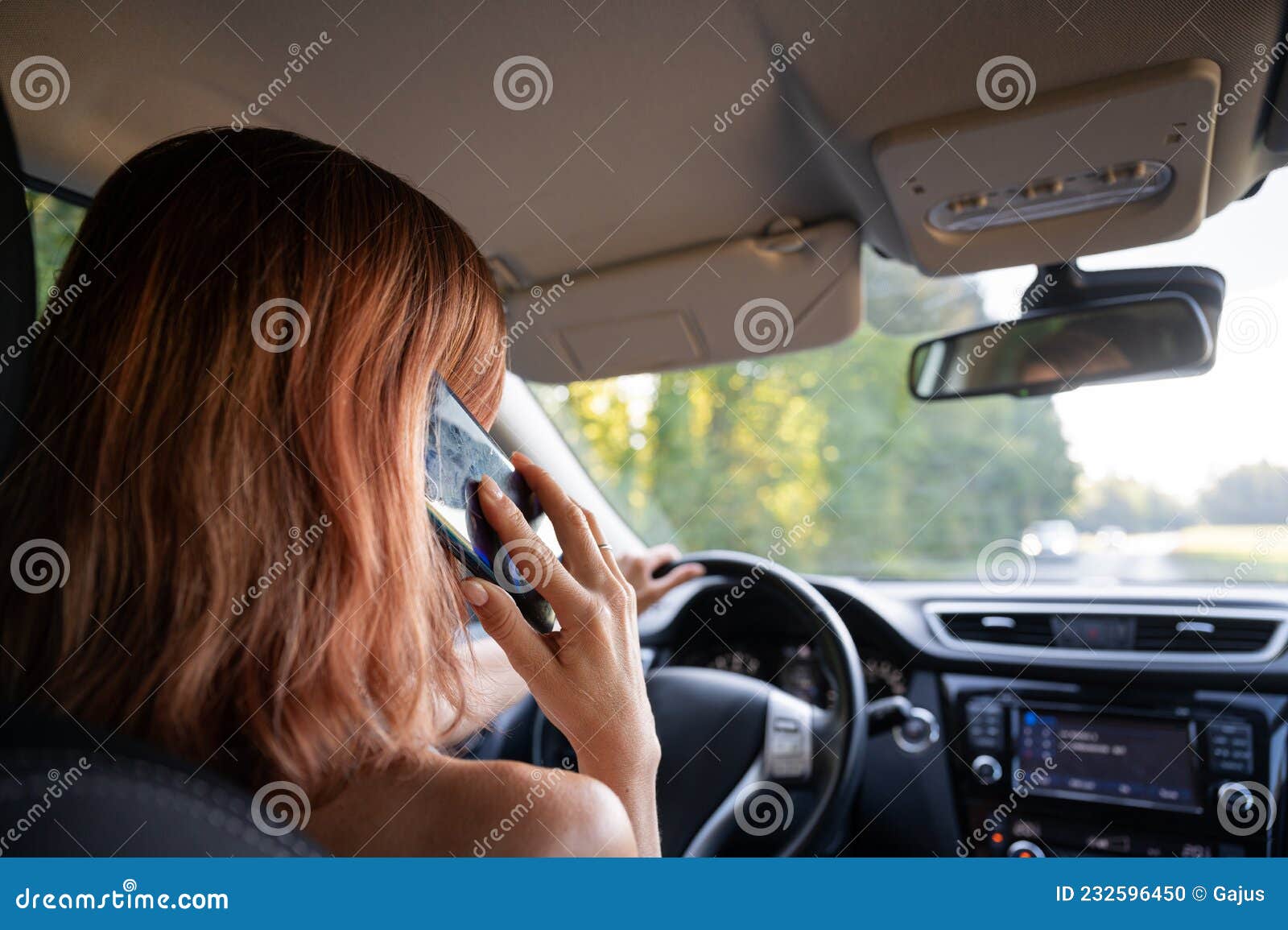 Woman Using Mobile Phone while Driving Stock Photo - Image of ...