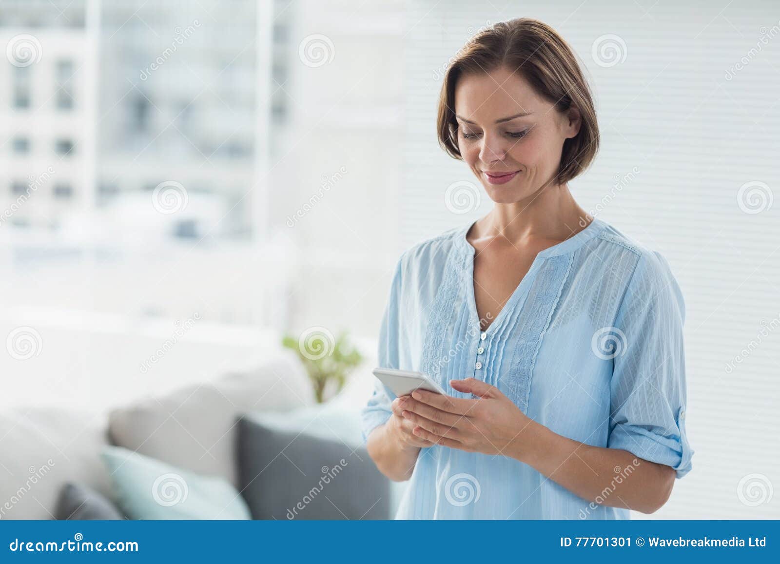 Woman using mobile phone stock image. Image of indoors - 77701301