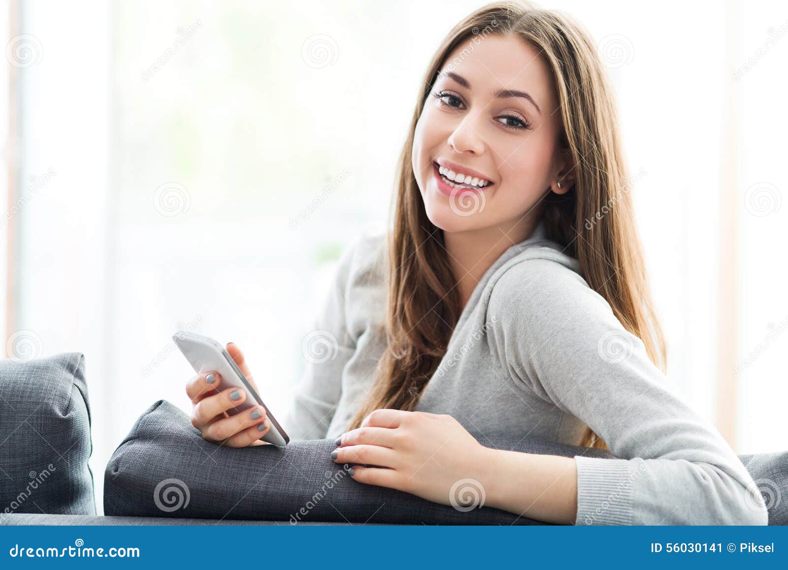 Woman Using Mobile Phone on Sofa Stock Image - Image of phone, people ...