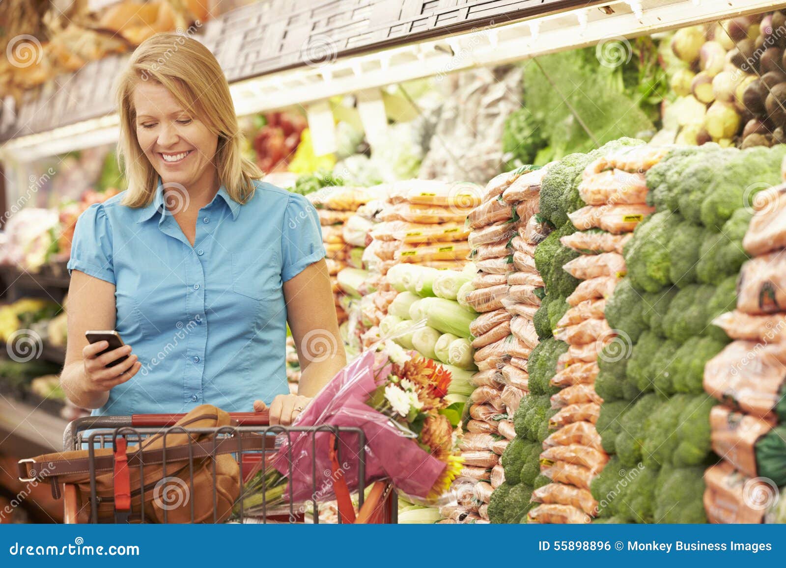 Woman Using Mobile Phone in Supermarket Stock Photo - Image of buying ...
