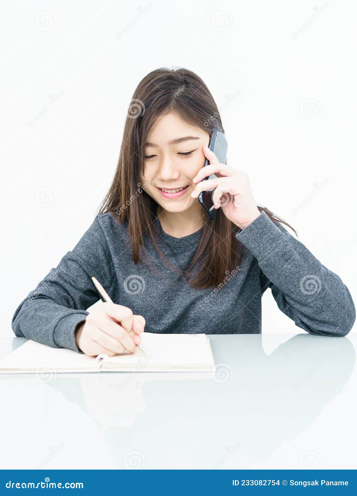Woman Using Mobile Phone and Writing Notebook Stock Photo - Image of ...