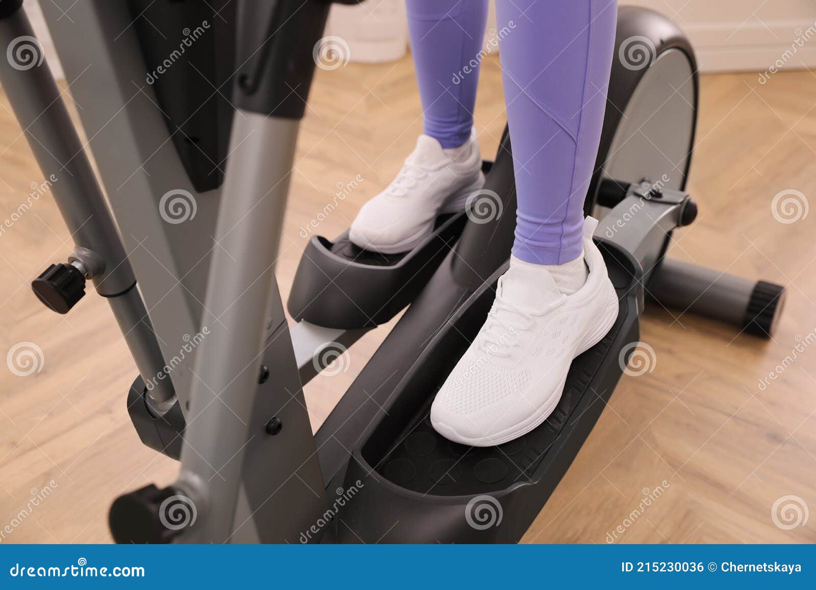 Woman Using Modern Elliptical Machine Indoors, Closeup Stock Photo ...