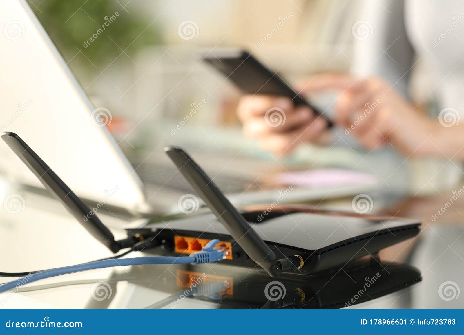 Woman Using Multiple Devices with Broadband Router on Foreground Stock ...