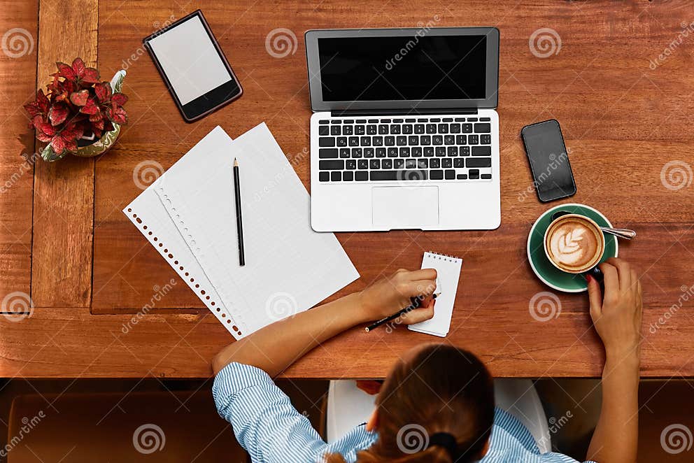 Woman Using Notebook Computer, Taking Notes at Cafe. Working. Stock ...