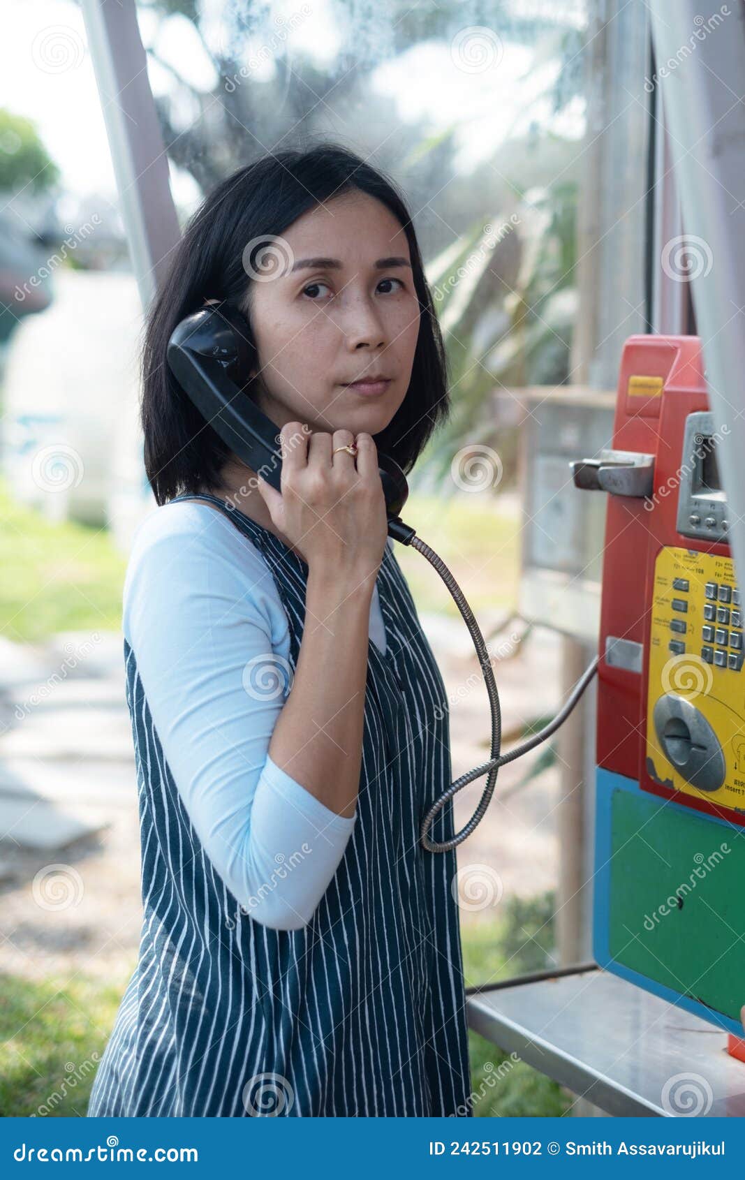 Woman Using Oldstyle Public Pay Phone in Telephone Booth Stock Photo ...