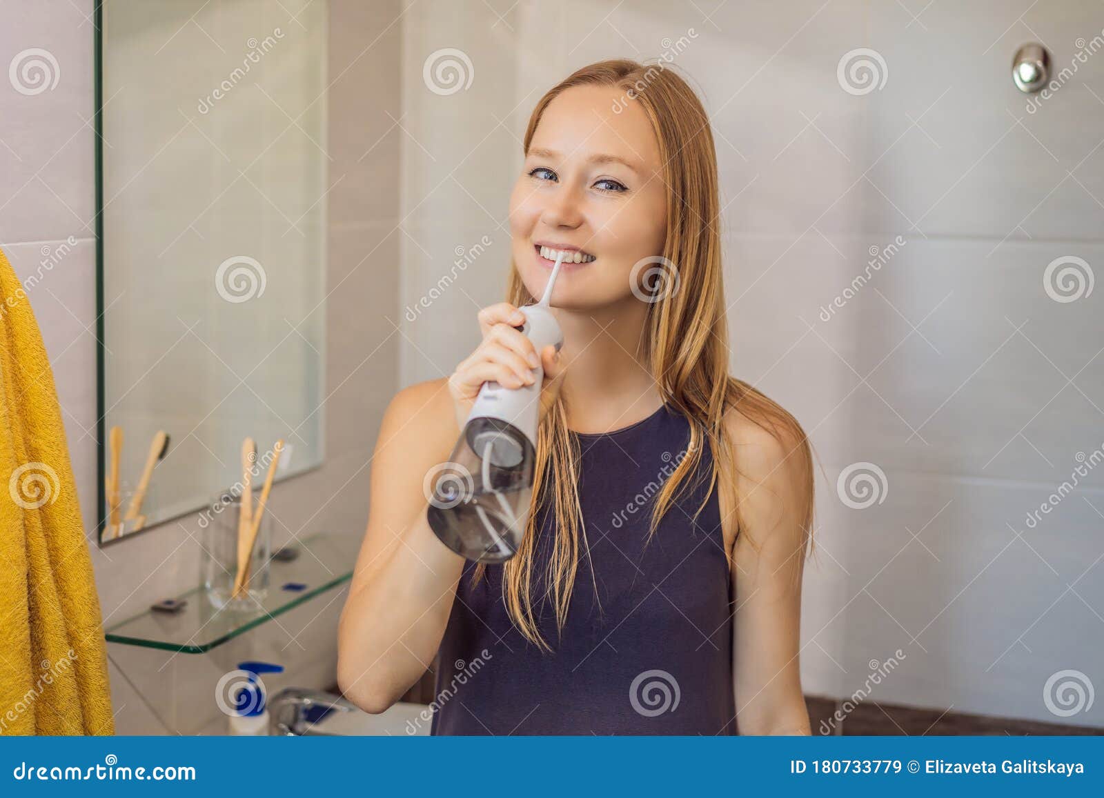 Woman Using an Oral Irrigator in Bathroom Stock Image - Image of ...