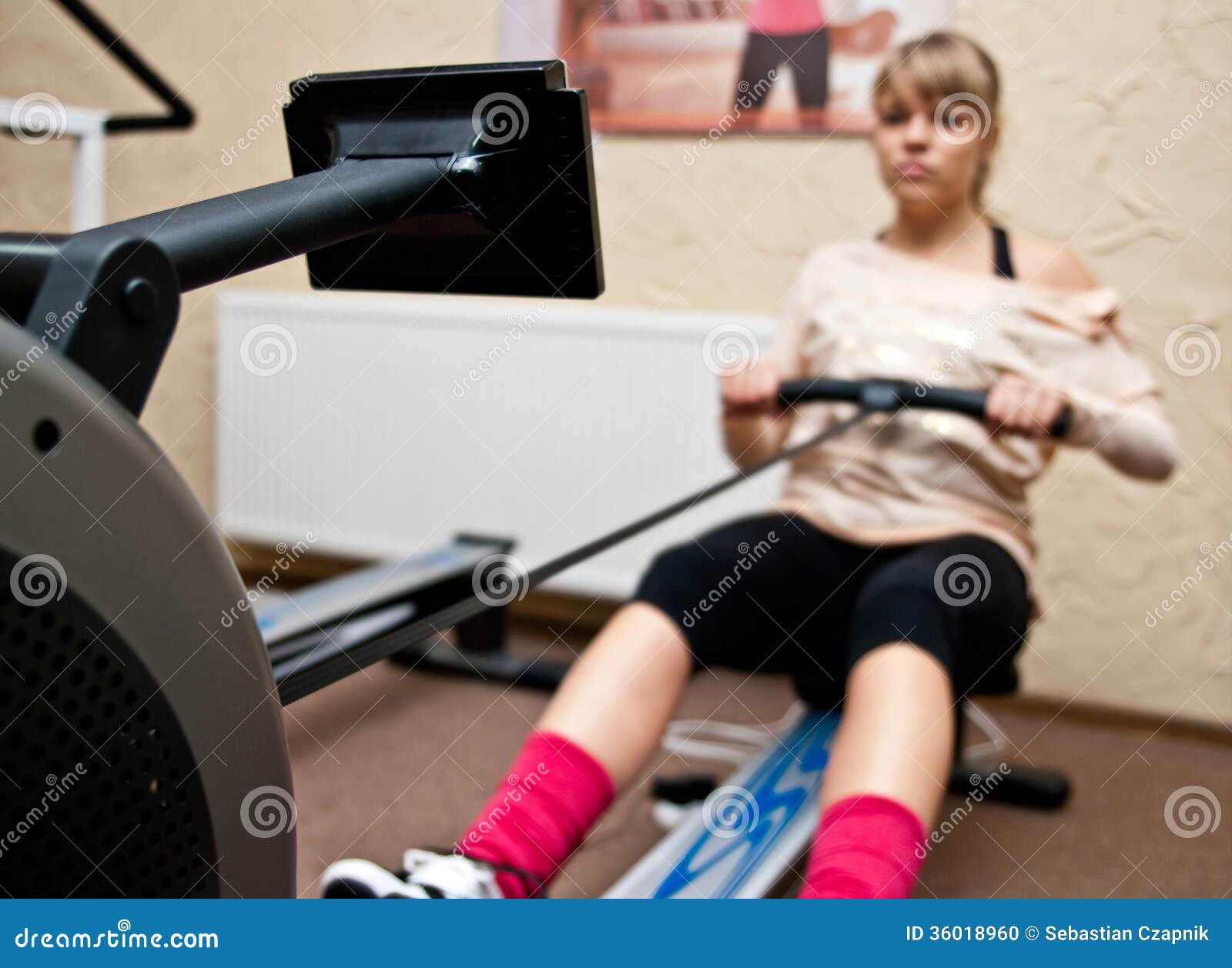 Woman using rowing machine stock photo. Image of machinery - 36018960
