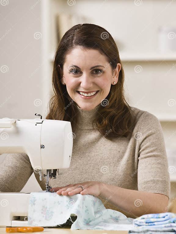 Woman Using Sewing Machine stock image. Image of house - 10320733