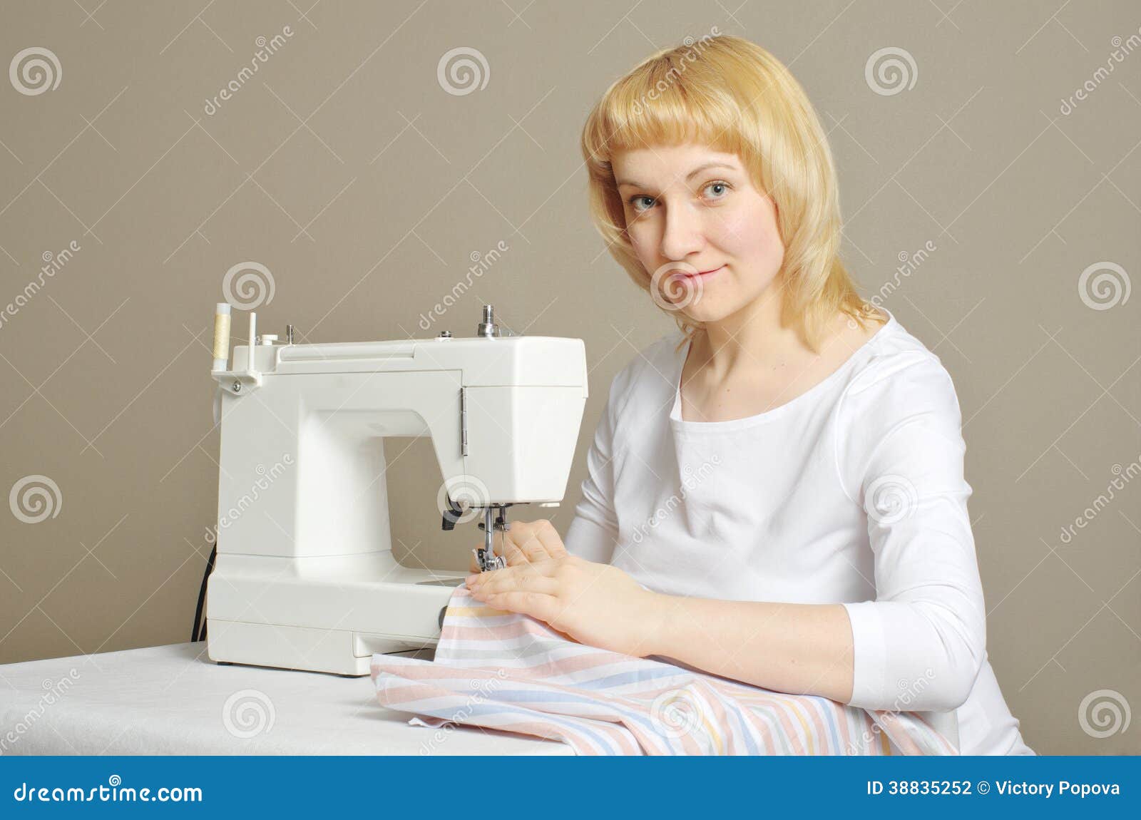 Woman using sewing machine stock photo. Image of female - 38835252