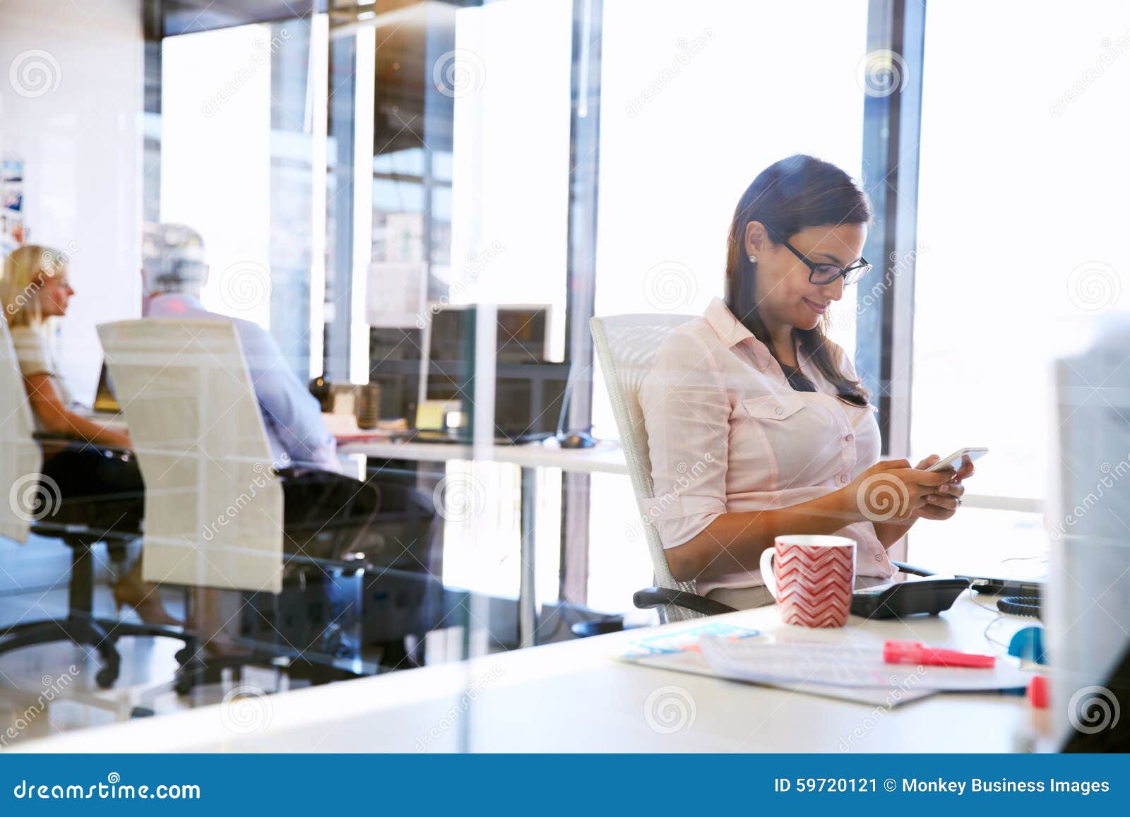 Woman Using Smart Phone,phone at Her Desk in an Office Stock Image ...