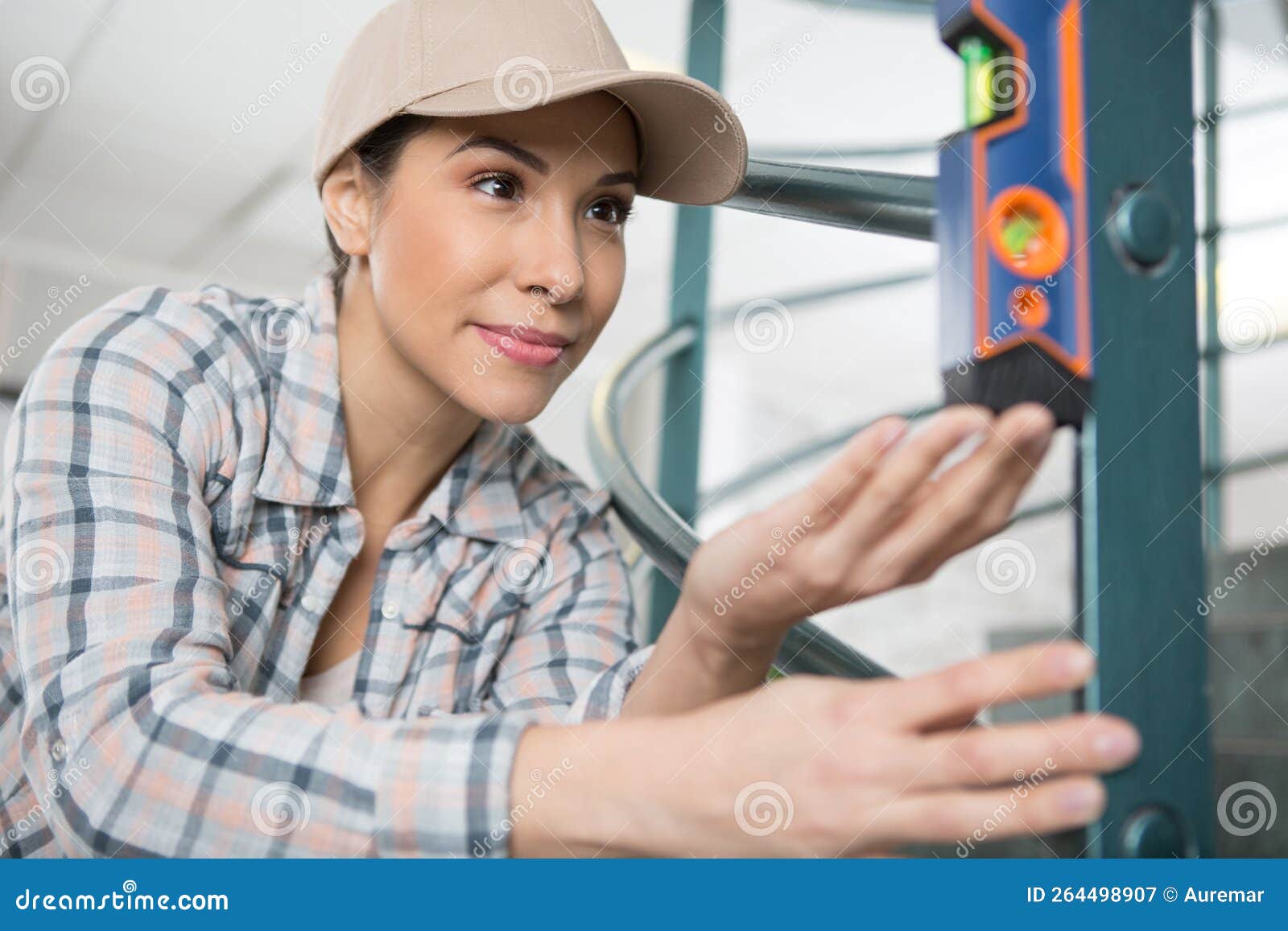 Woman using spirit level stock image. Image of woman - 264498907