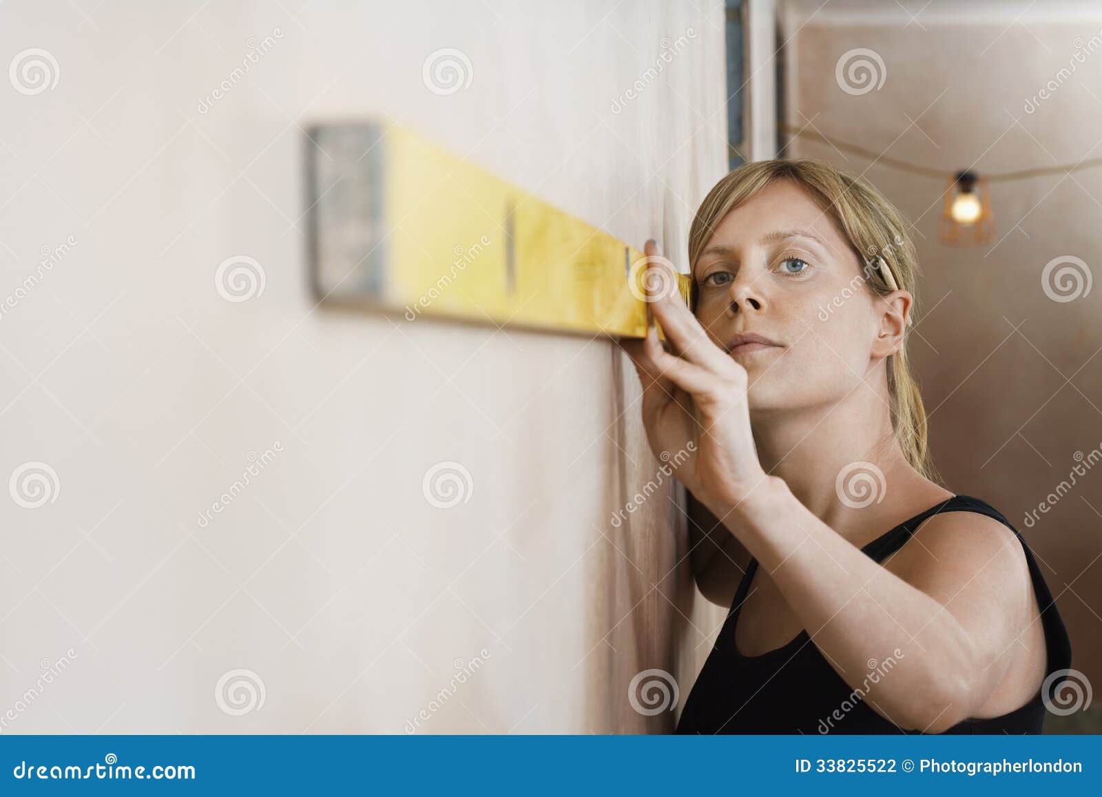 Woman Using Spirit Level stock photo. Image of level - 33825522