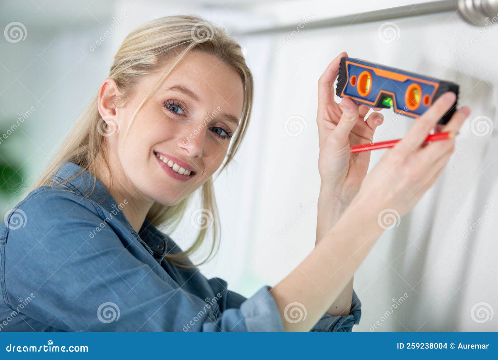 Woman Using Spirit Level and Marking Wall Stock Photo - Image of spirit ...
