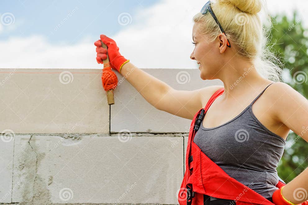 Woman Using String As Level in Wall Construction Stock Image - Image of ...