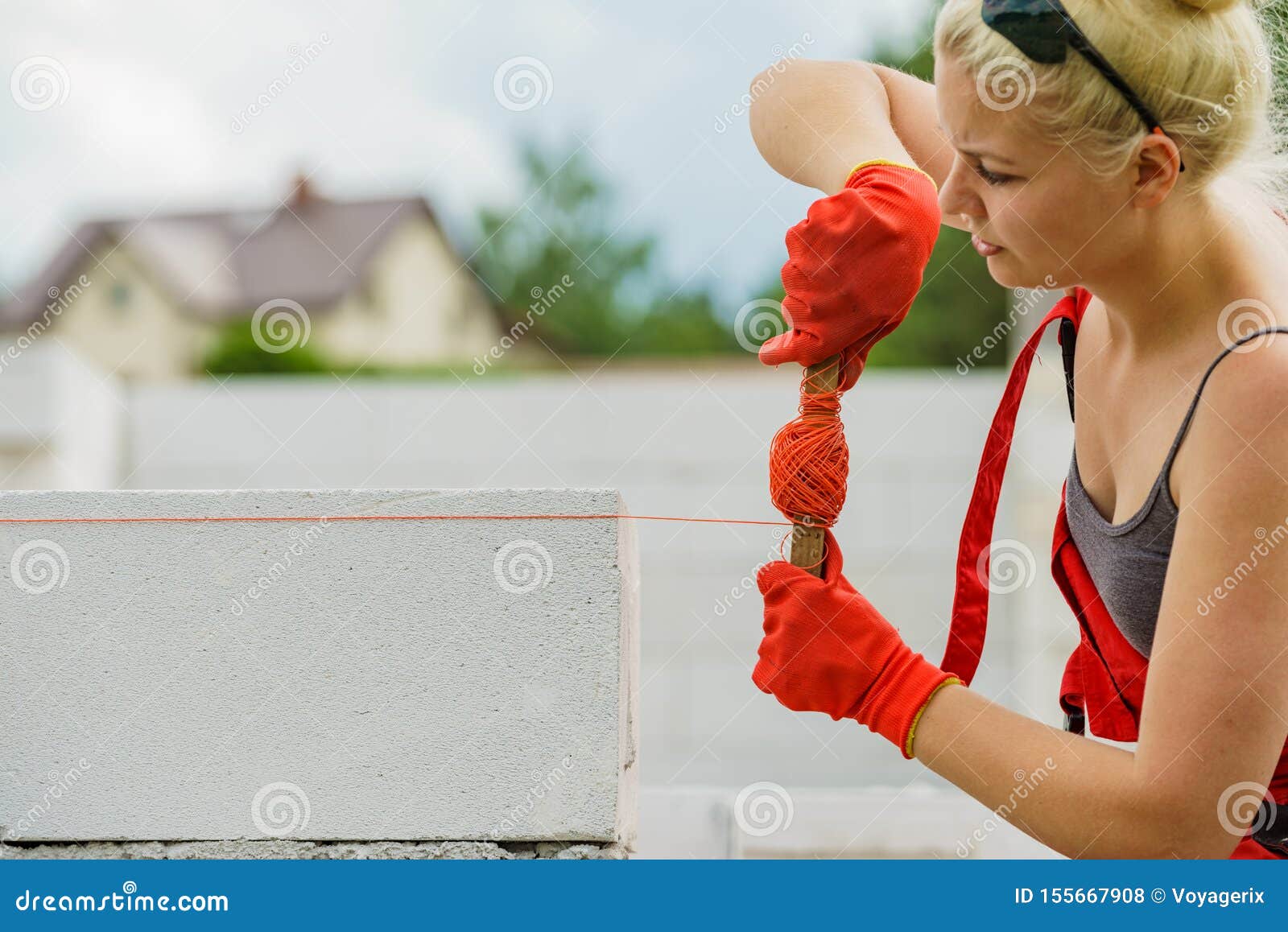 Woman Using String As Level in Wall Construction Stock Photo - Image of ...