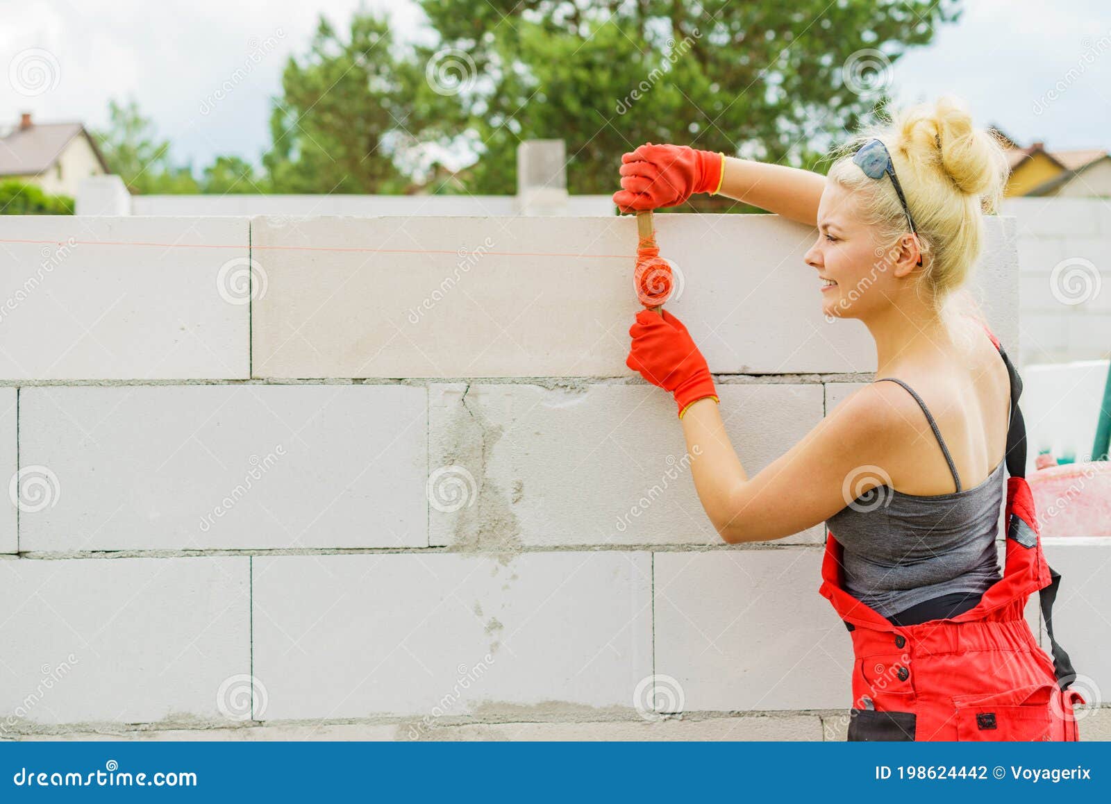 Woman Using String As Level in Wall Construction Stock Photo - Image of ...