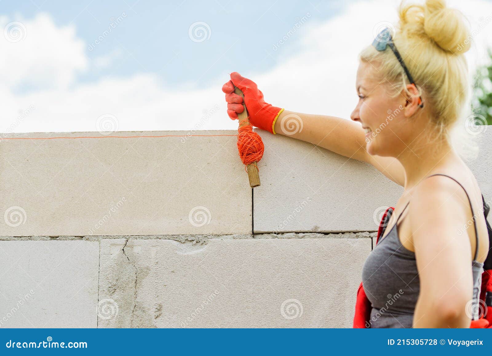 Woman Using String As Level in Wall Construction Stock Photo - Image of ...
