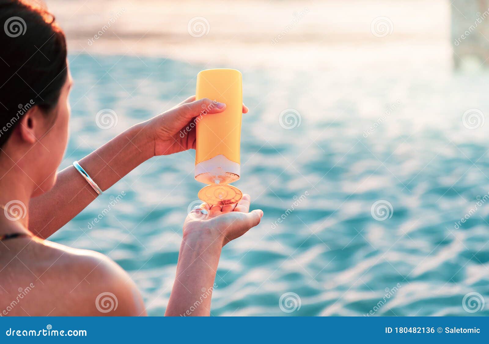Woman Using Sun Lotion on the Beach Stock Photo - Image of skin, person ...