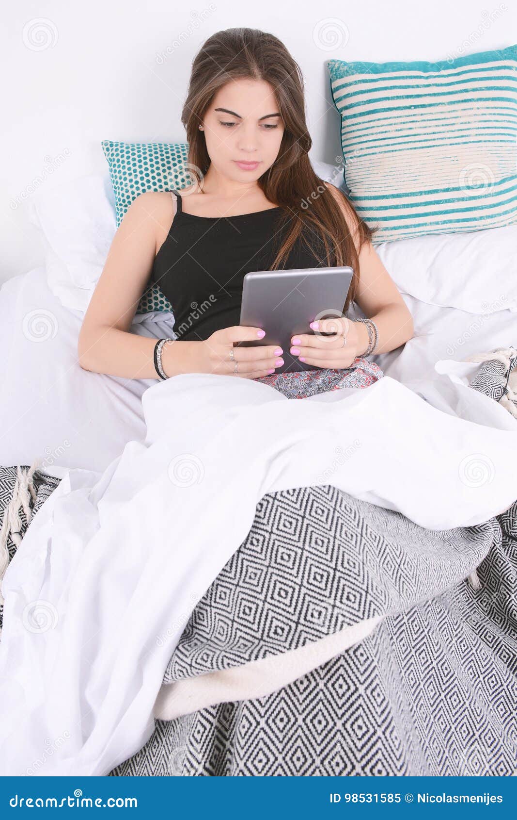 Woman using tablet on bed. stock image. Image of beautiful - 98531585