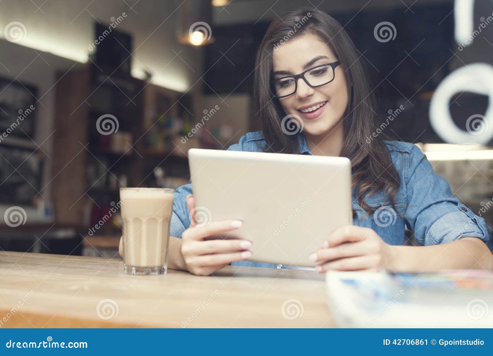 Woman using tablet in cafe stock image. Image of restaurant - 42706861