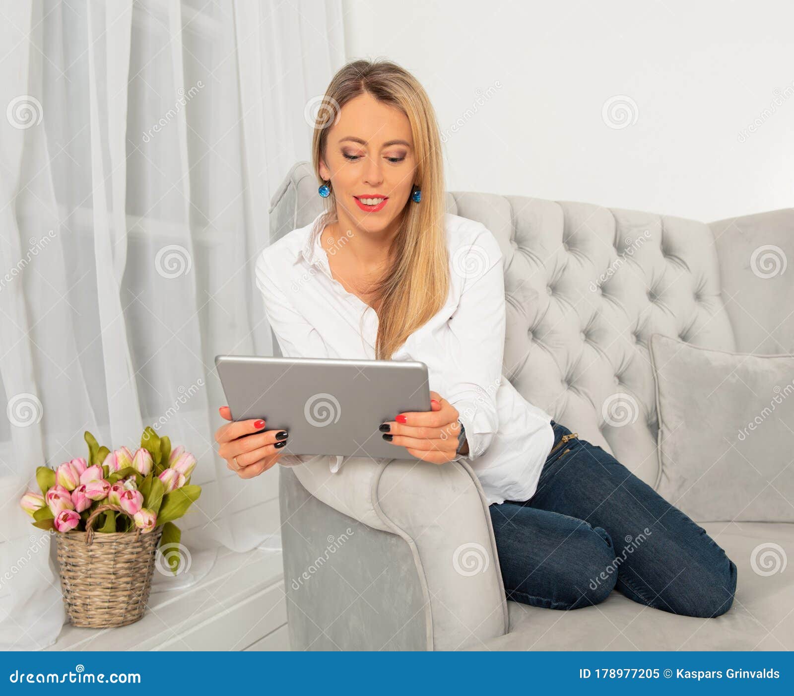 Woman Using Tablet Computer while Sitting in Sofa Stock Image - Image ...