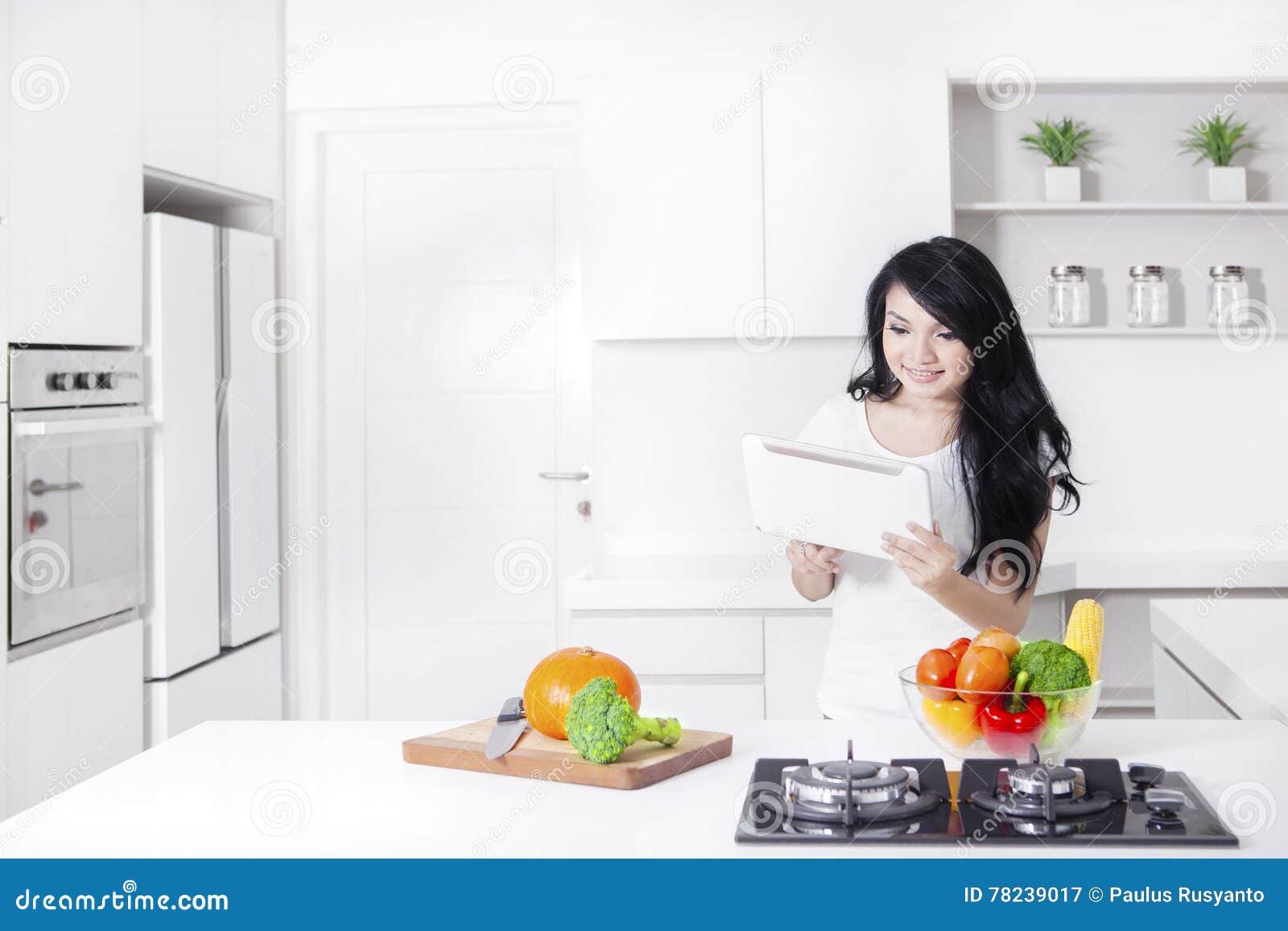 Woman Using Tablet in Kitchen Stock Image - Image of knife, board: 78239017