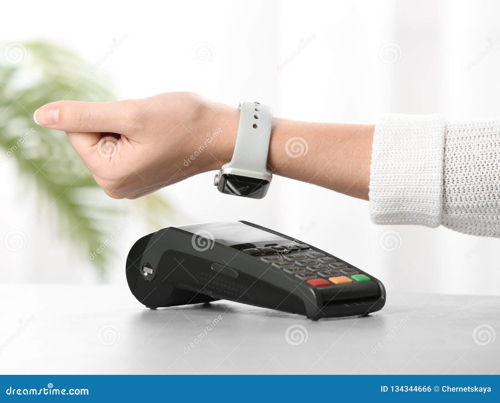 Woman Using Terminal for Contactless Payment with Smart Watch at Table ...
