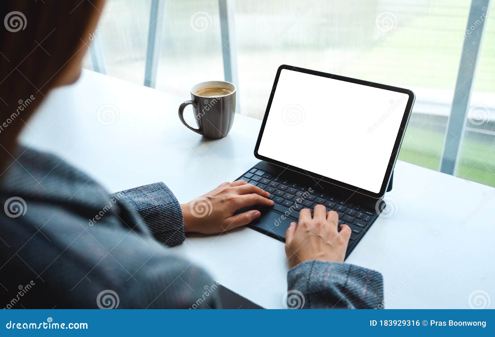A Woman Using and Typing on Tablet Keyboard with Blank White Desktop ...