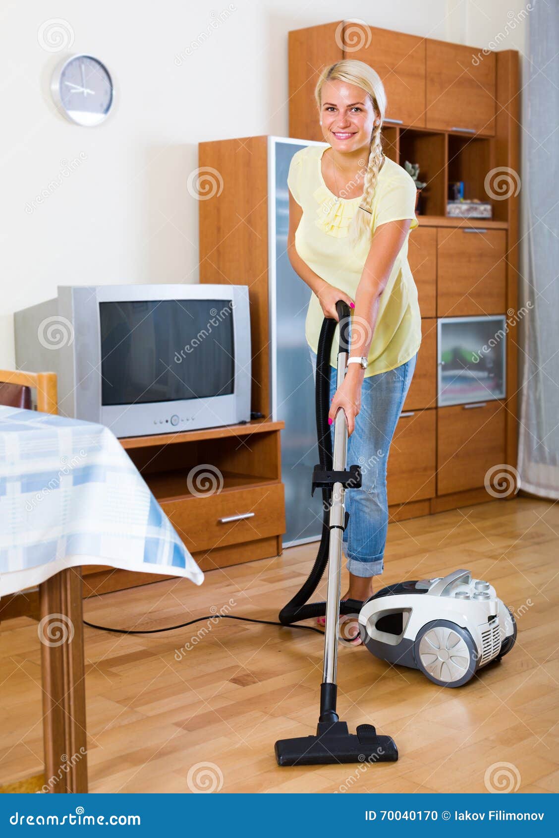 Woman using vacuum cleaner stock photo. Image of furniture - 70040170