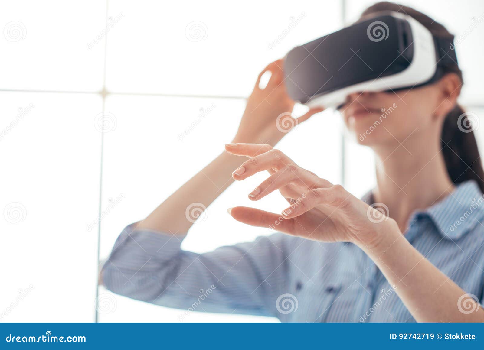 Woman using a VR headset stock image. Image of technology - 92742719