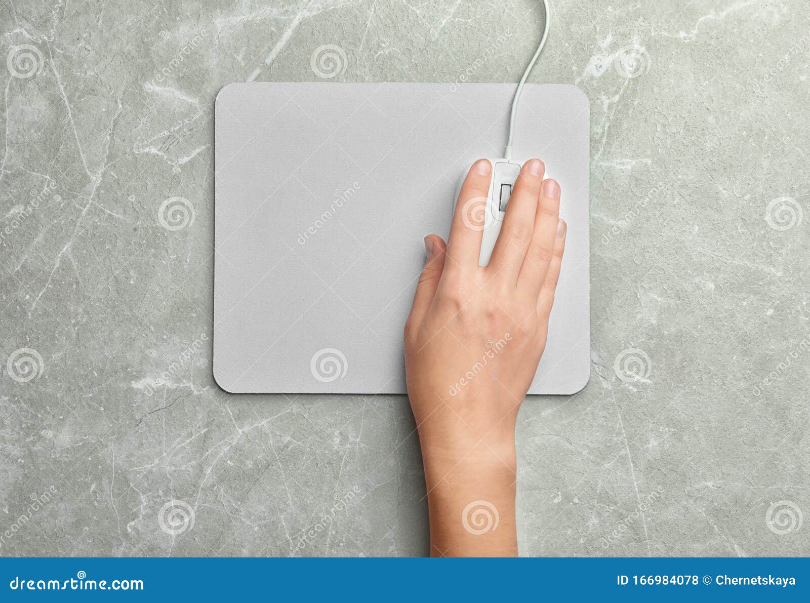 Woman Using Wired Computer Mouse on Grey Marble Table, Top View. Space ...