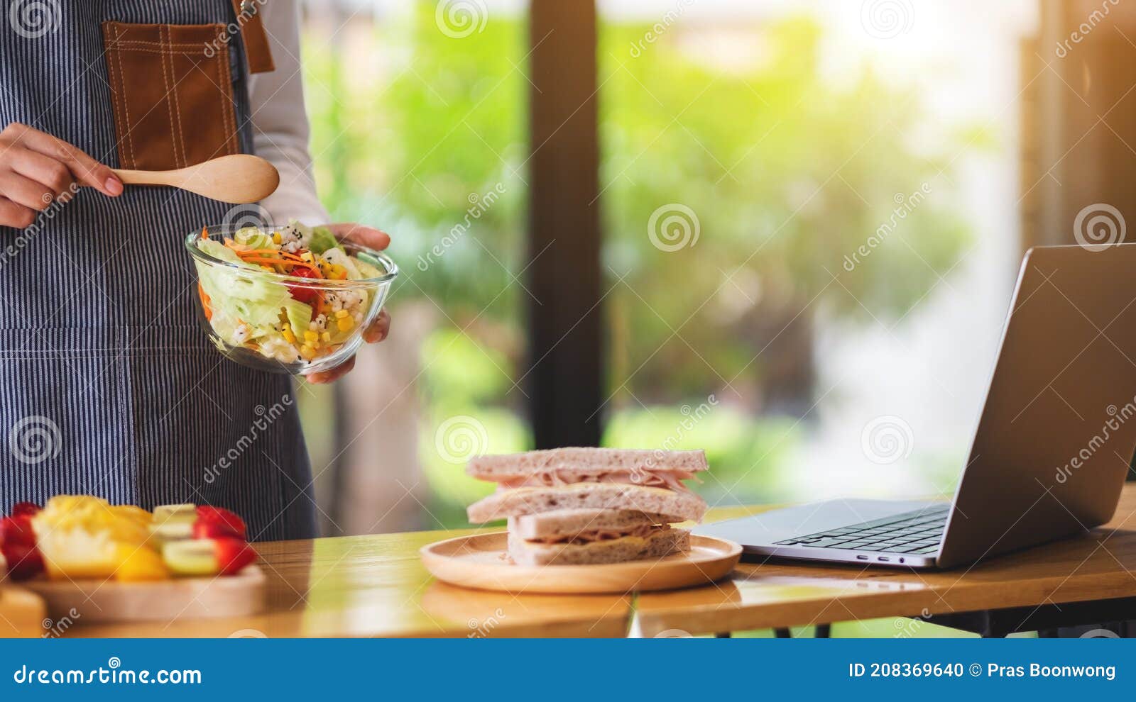 A Woman Videoblogger Cooking in the Kitchen and Filming, Online ...