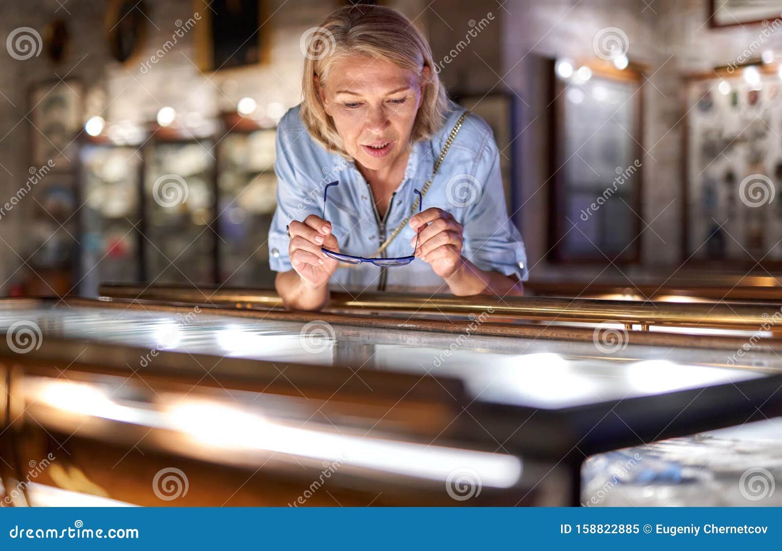 Woman Visitor in the Historical Museum Looking at Art Object. Stock ...