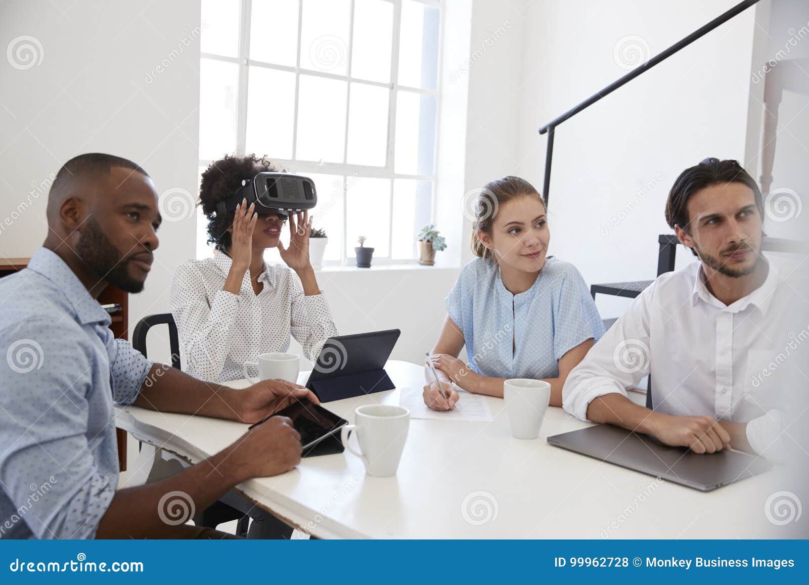 Woman in VR Goggles at a Desk with Colleagues in an Office Stock Photo ...