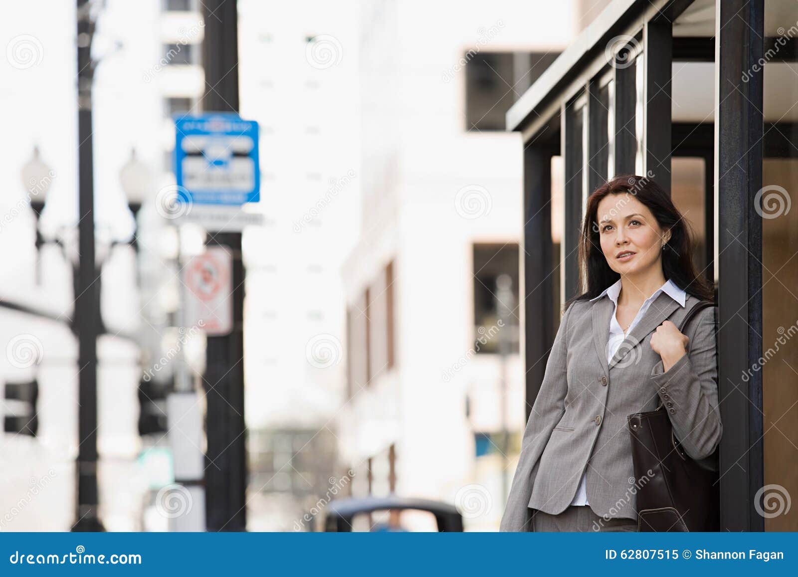 Woman waiting at bus stop stock image. Image of adult - 62807515