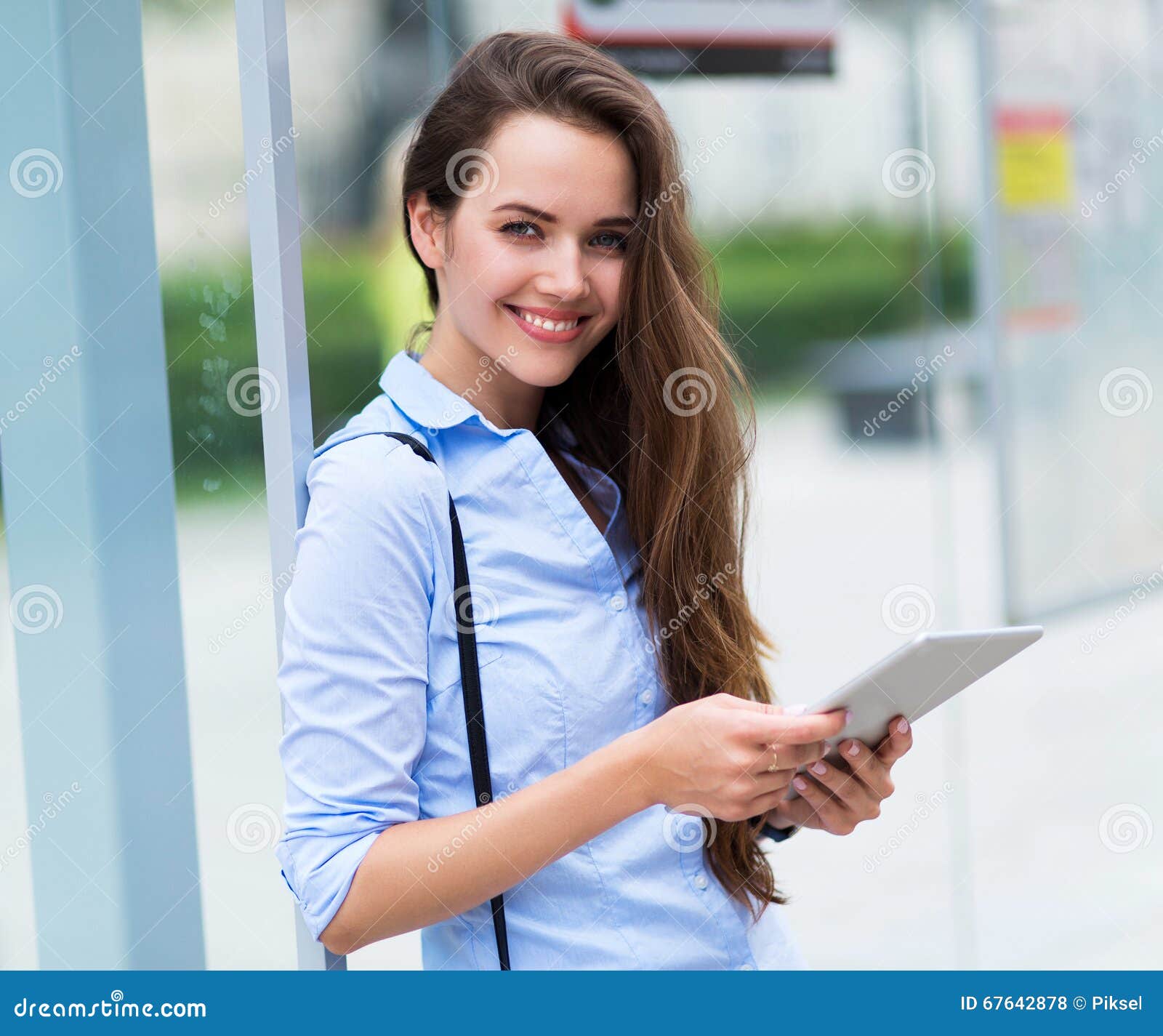 Woman waiting at bus stop stock photo. Image of carefree - 67642878