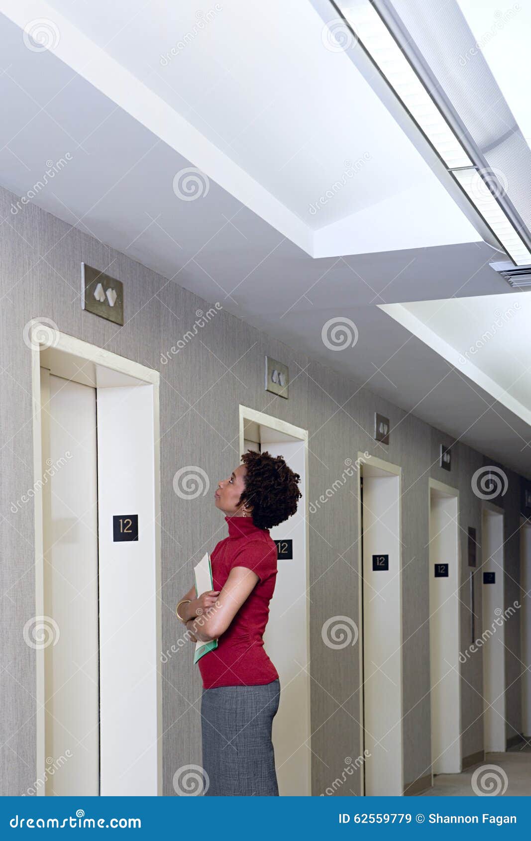 Woman waiting for elevator stock image. Image of black - 62559779