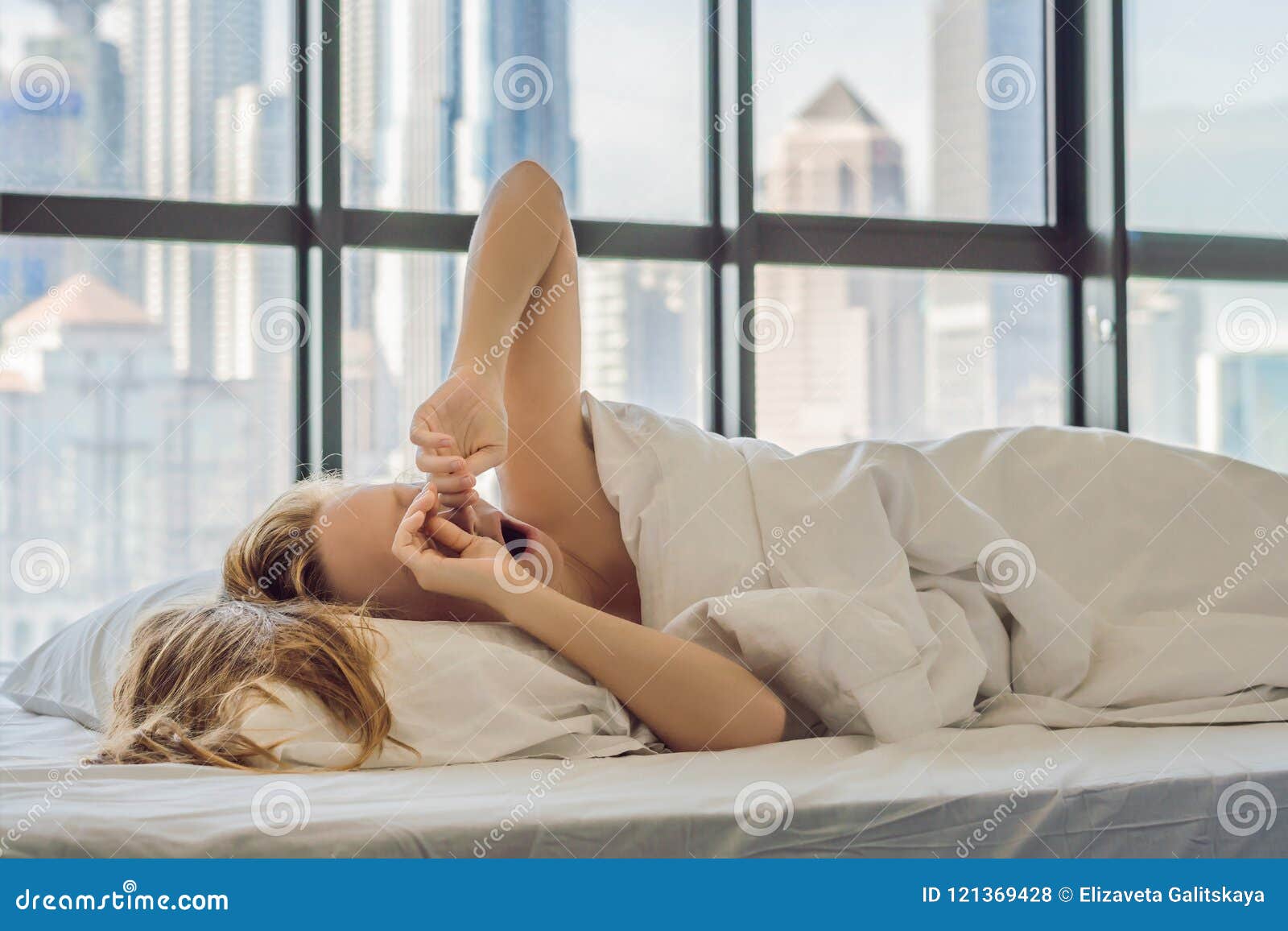 Woman Wakes Up in the Morning in an Apartment in the Downtown Ar Stock ... Woman Wakes Up in the Morning in an Apartment in the Downtown Ar Stock ...